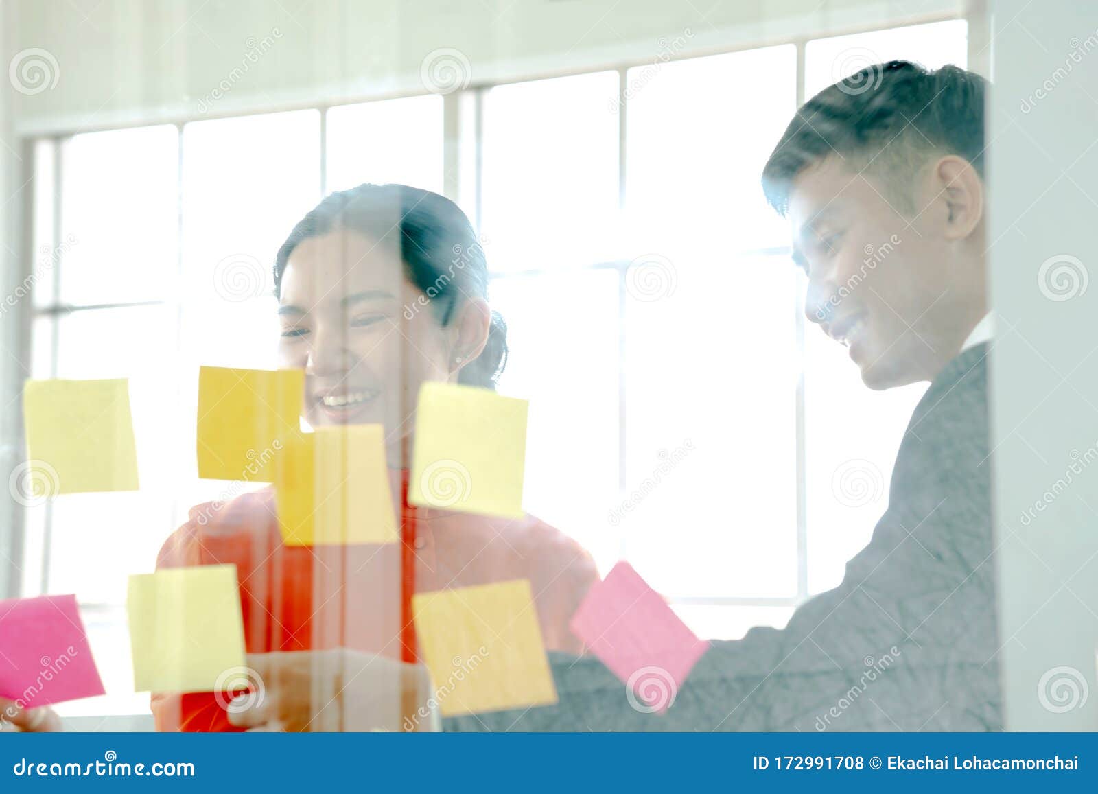 Young People Making Plans on a Glass Wall at Casual Office Stock Photo ...