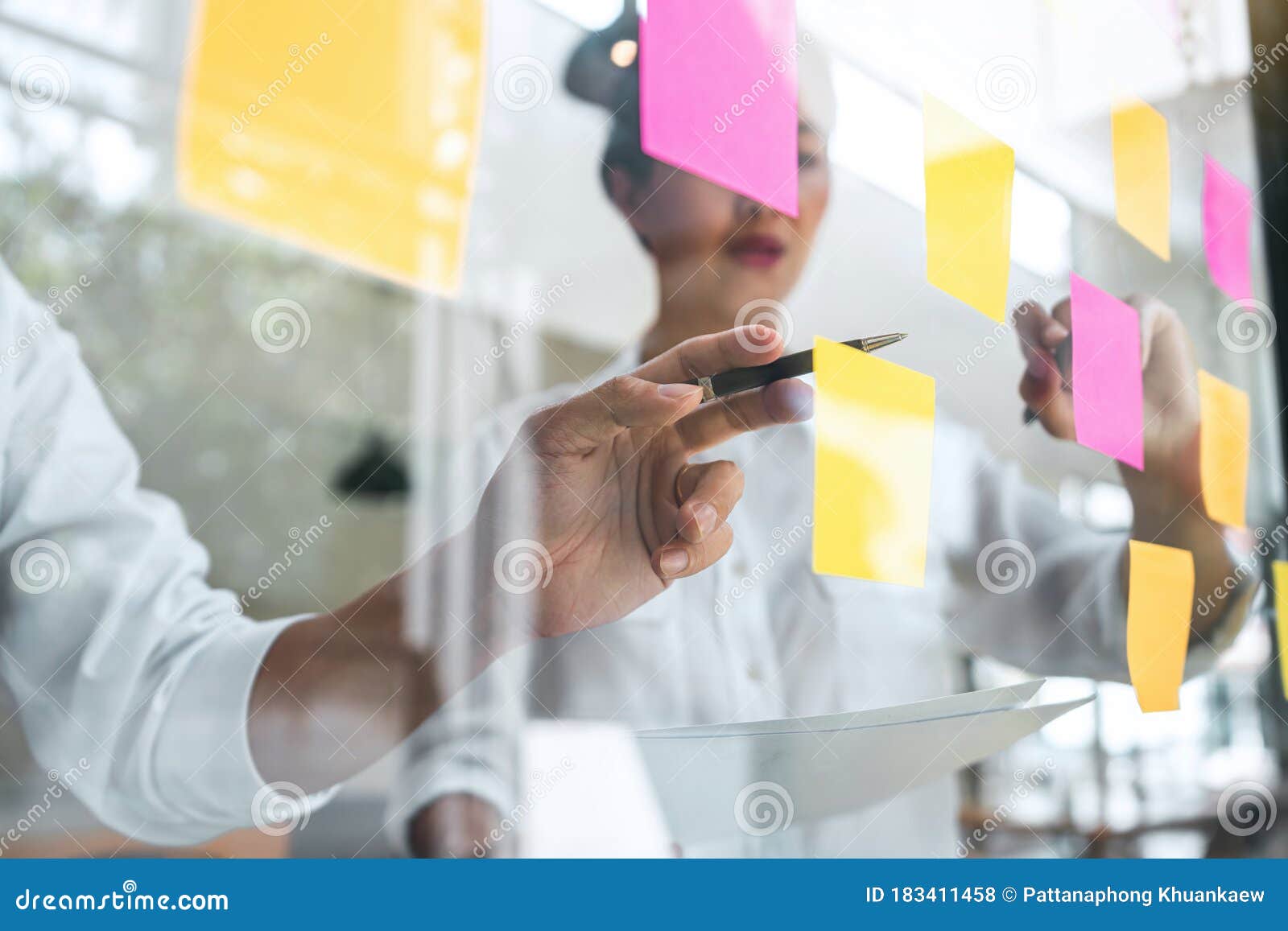 Young Creative Team Professional Using Post it Notes in Glass Wall To ...