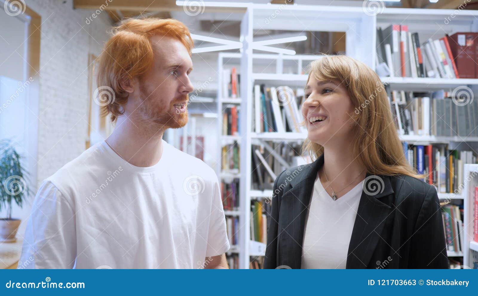 Young Creative Team Smiling while Having a Conversation in Office Stock ...