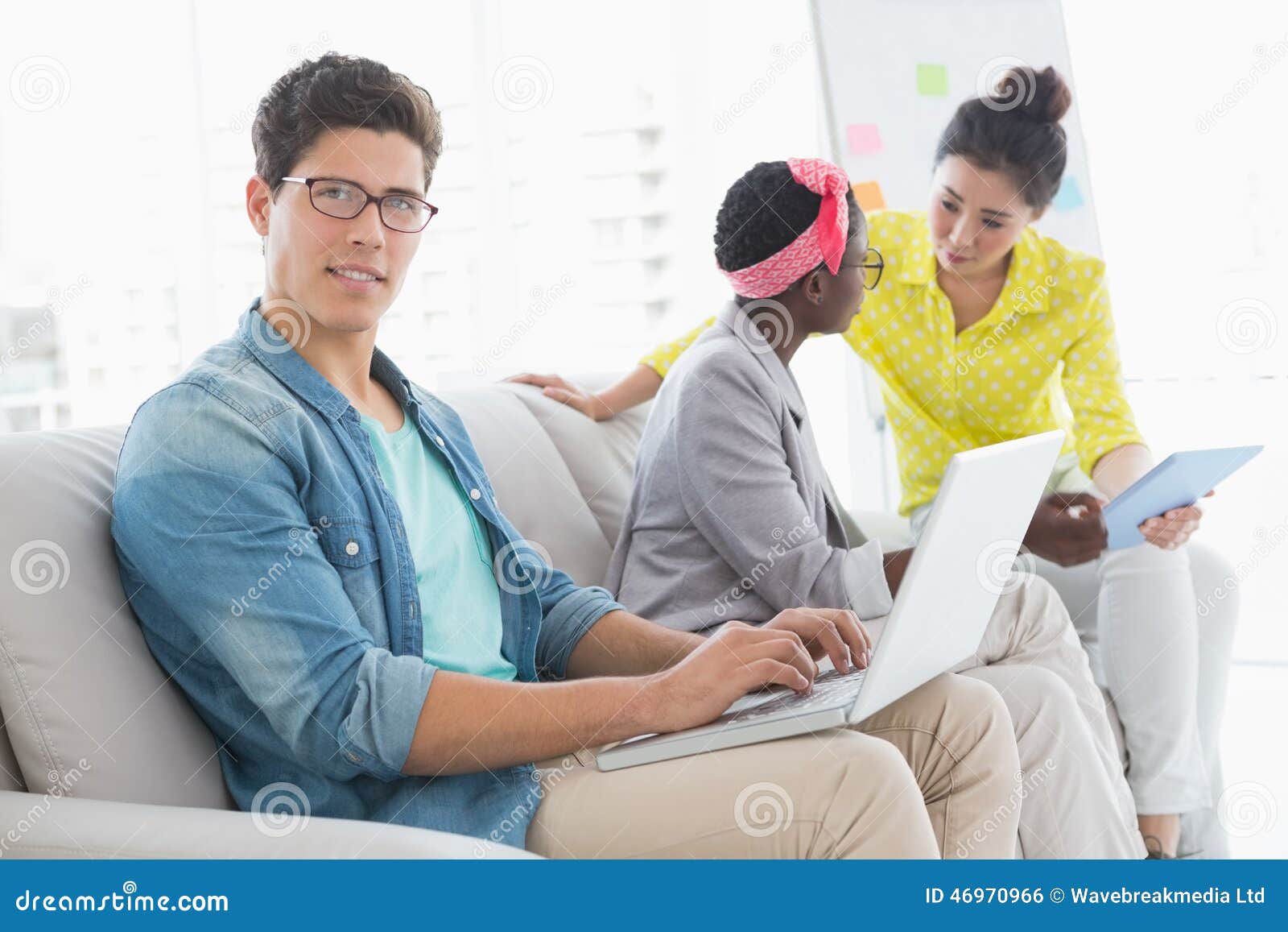 Young Creative Team Working on Couch Stock Photo - Image of design ...