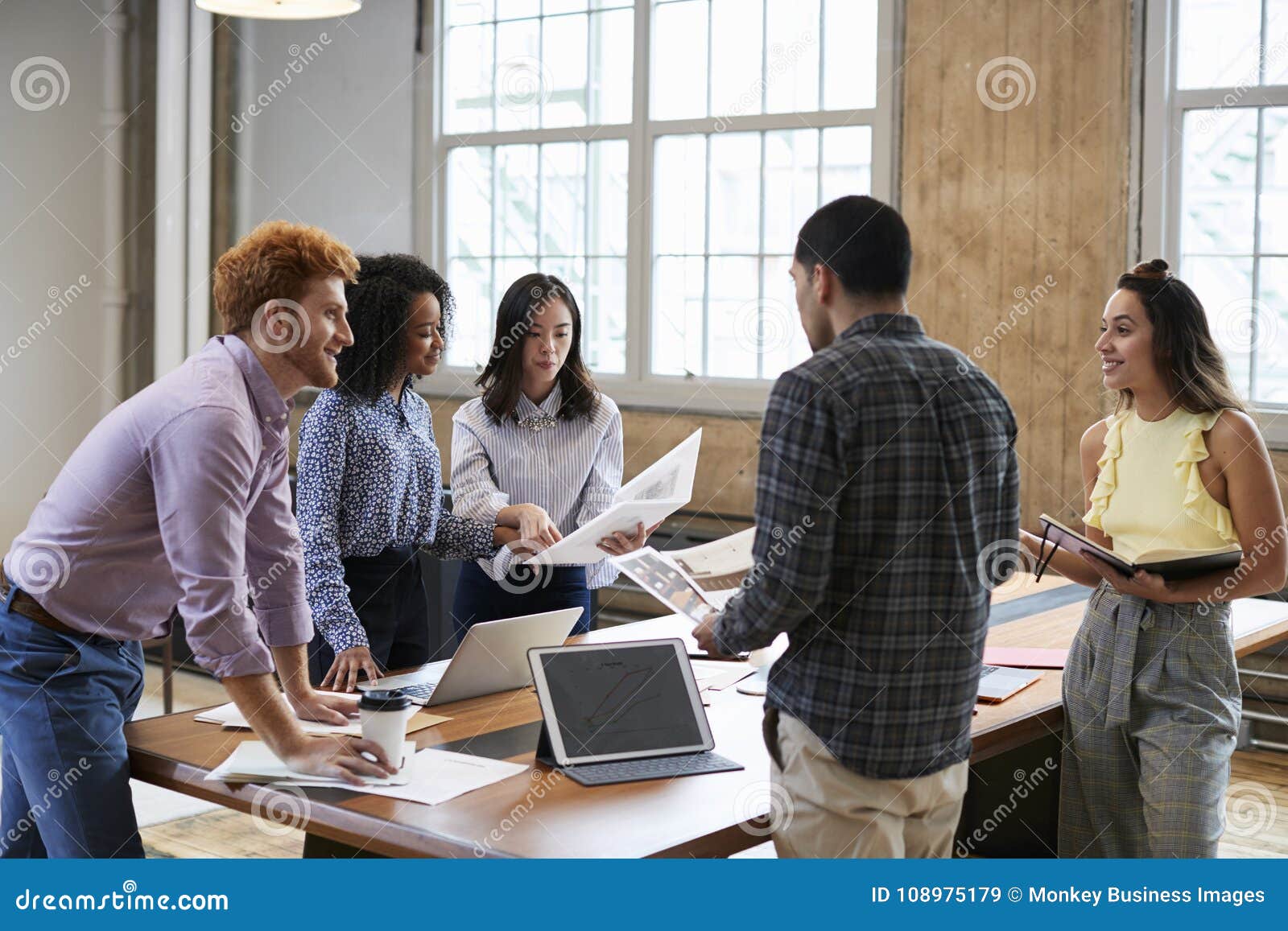 Young Creatives Brainstorming Around a Table at Work Stock Image ...