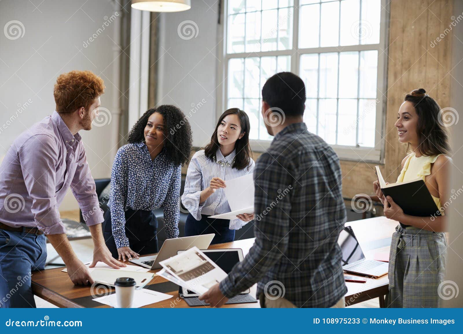 Young Creatives Brainstorming Ideas Around a Table Stock Image - Image ...