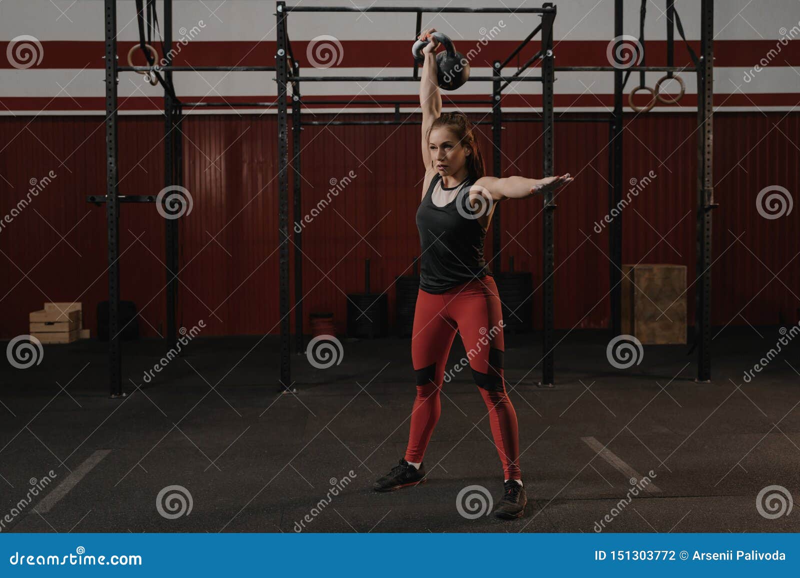 Young Crossfit Woman Lifting A Heavy Weight Kettlebell At Gym Stock