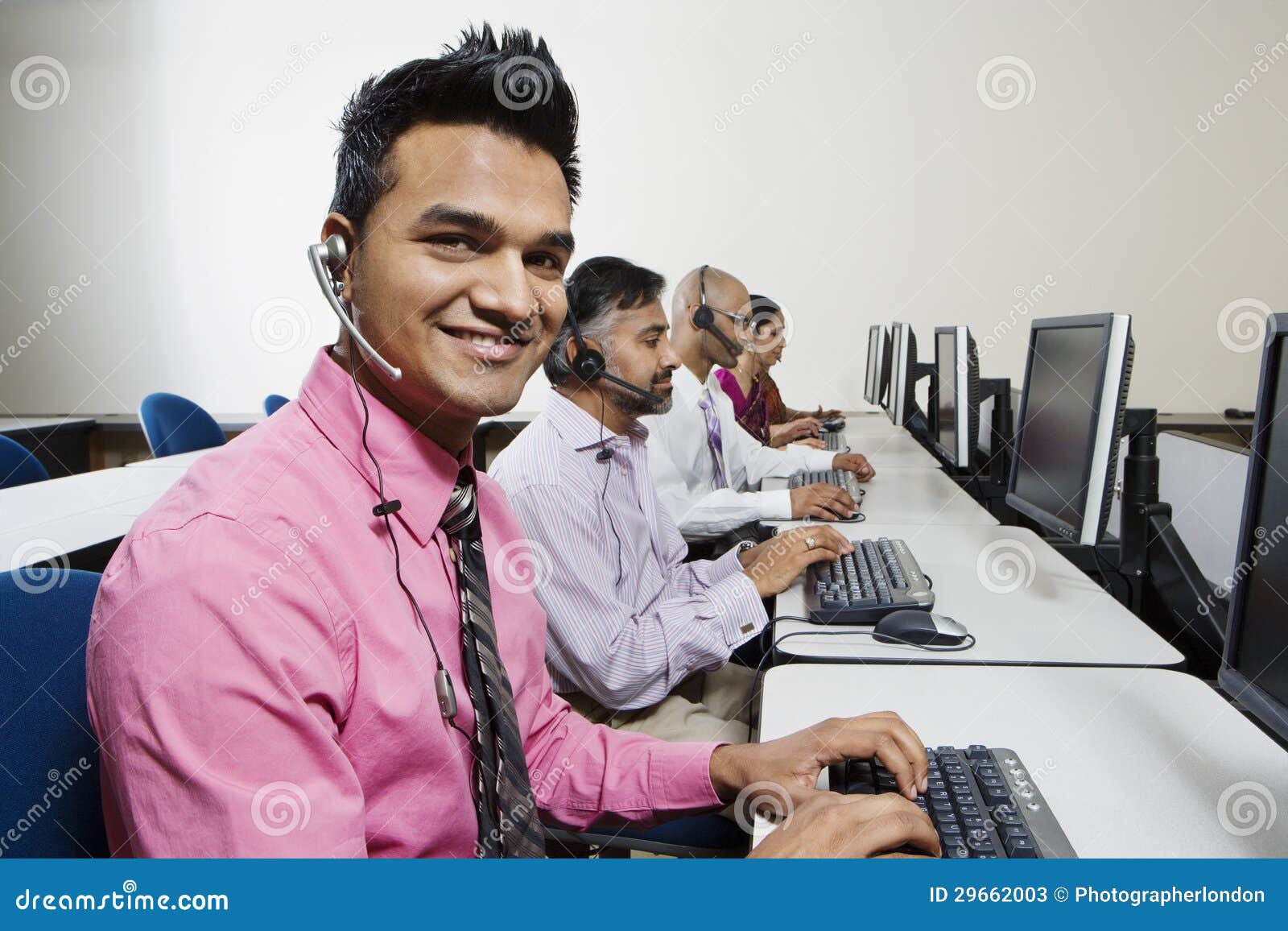 Young Customer Service Operator with Colleagues in the Office Stock ...