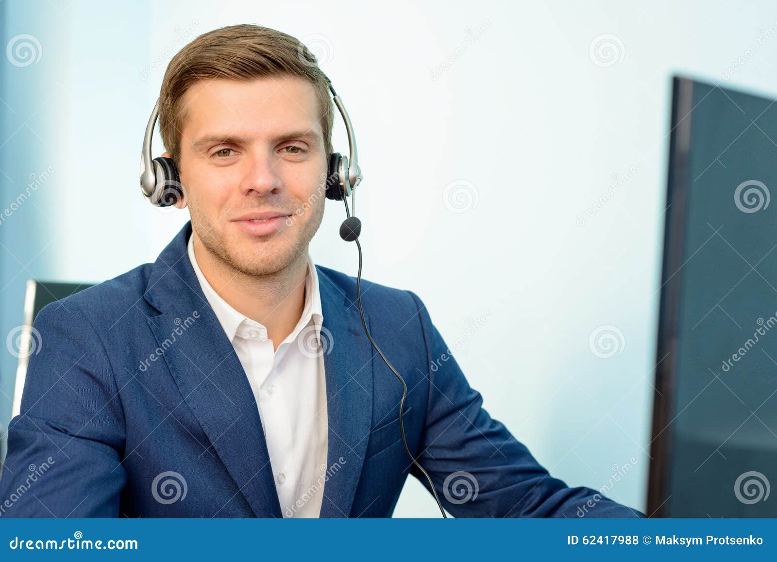 Young Customer Support Phone Operator with Headset at His Working Place ...