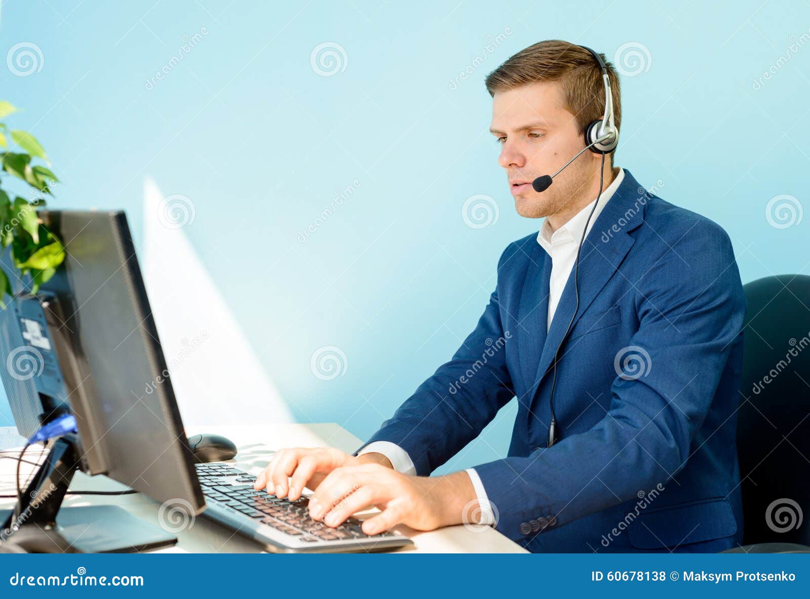 Young Customer Support Phone Operator with Headset Working in the ...