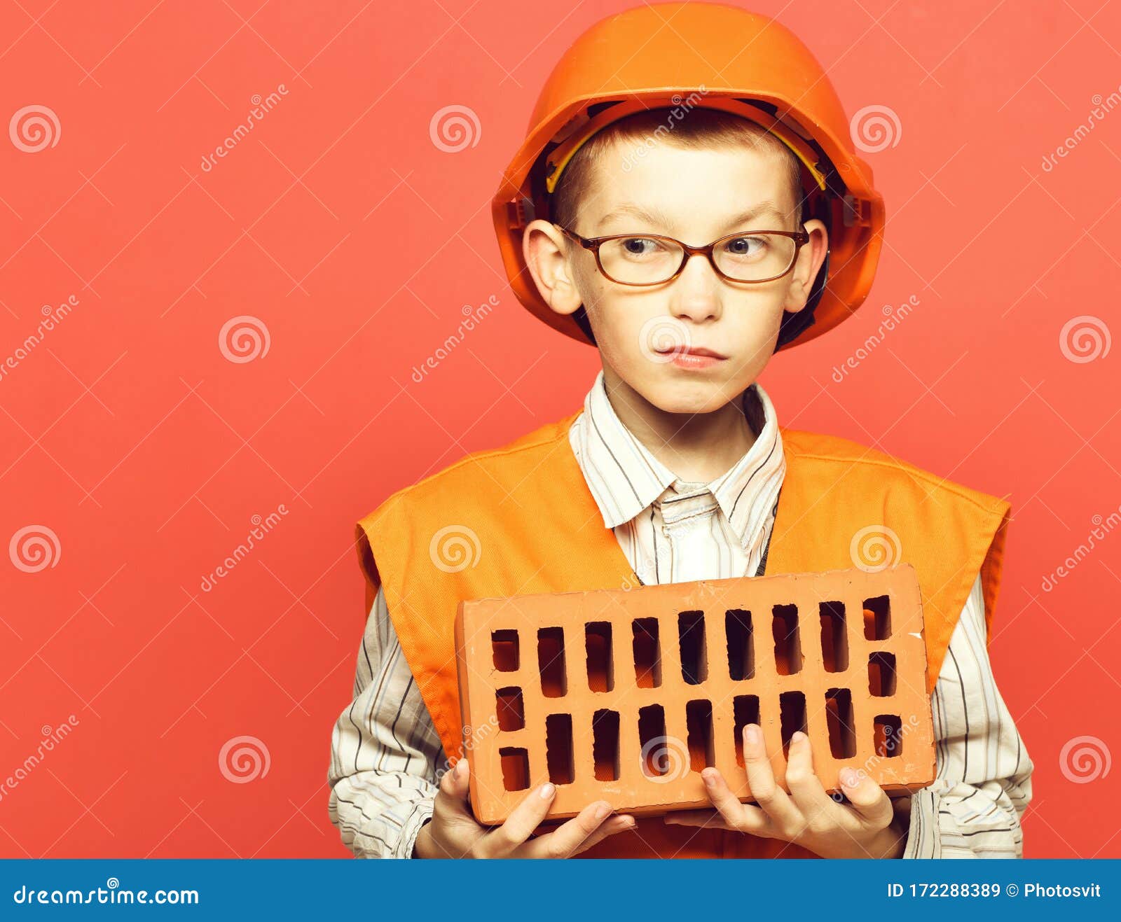 Young Cute Builder Boy on Red Studio Background, Copy Space Stock Image ...