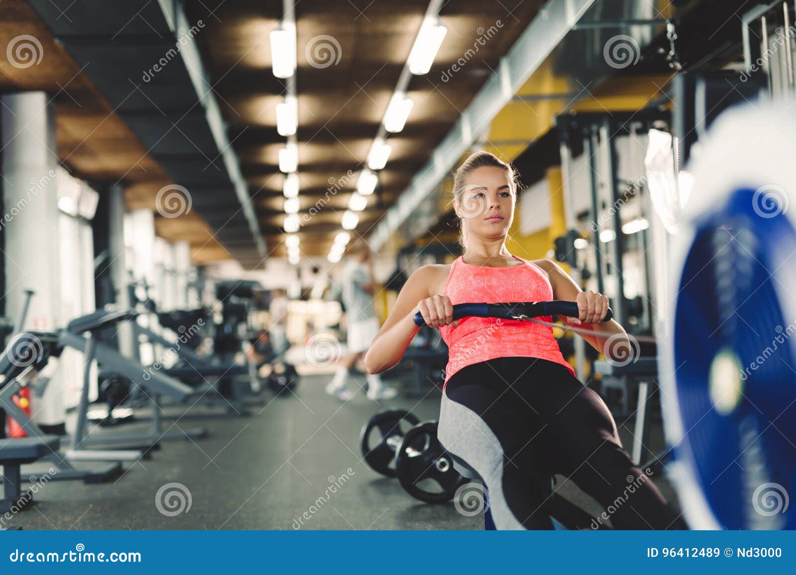 Young Cute Woman Doing Exercises with Rowing Machine Stock Image ...