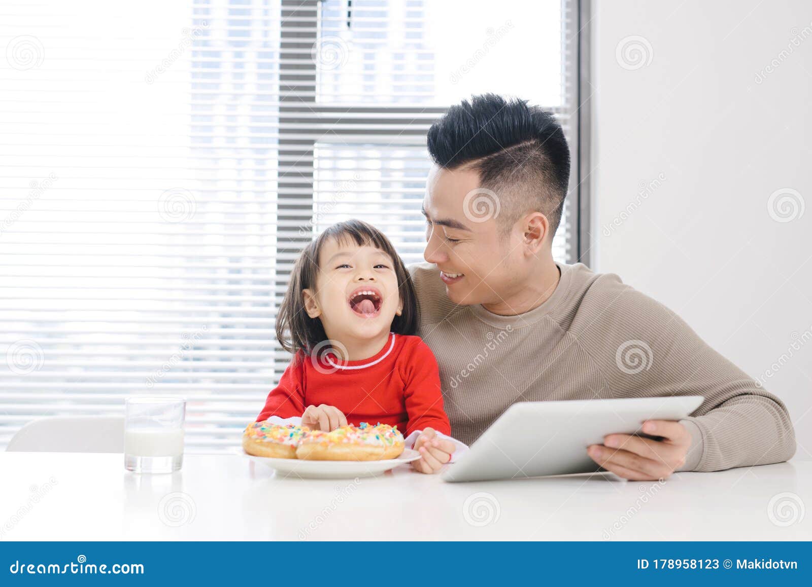 Young Dad and His Daughter Eating Pizza and Using Ipad Stock Image ...