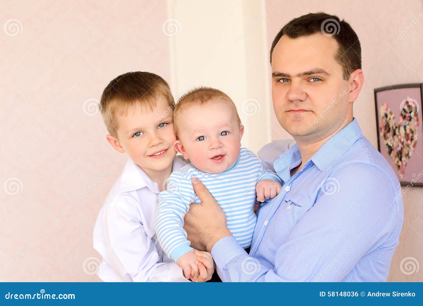 Young Daddy and Two Little Sons Stock Photo - Image of hugging, indoors ...