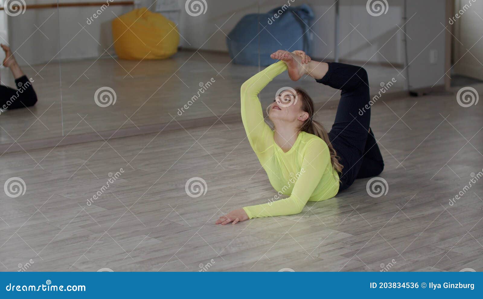 A Young Dancer Stretches before a Dance Training Session at a Dance ...