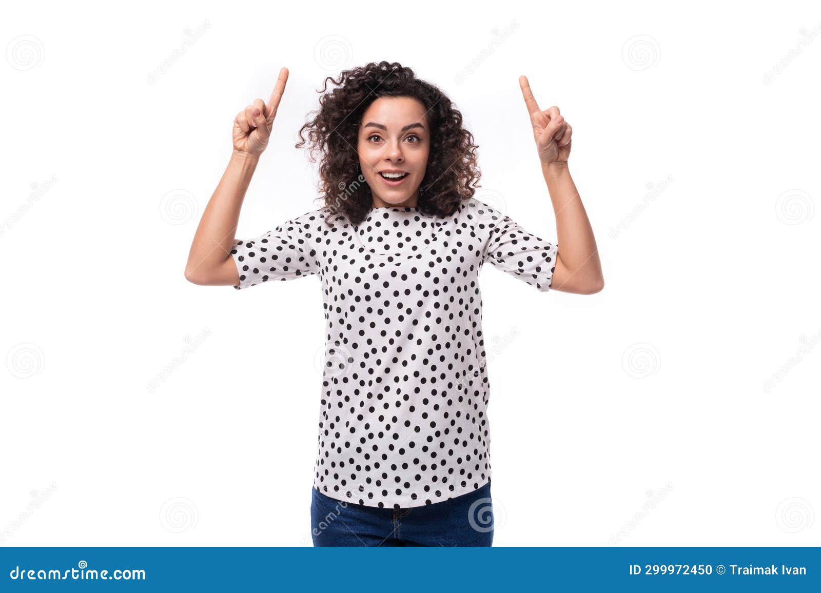 Young Dark Haired Caucasian Woman Dressed In A Blouse Points With Her