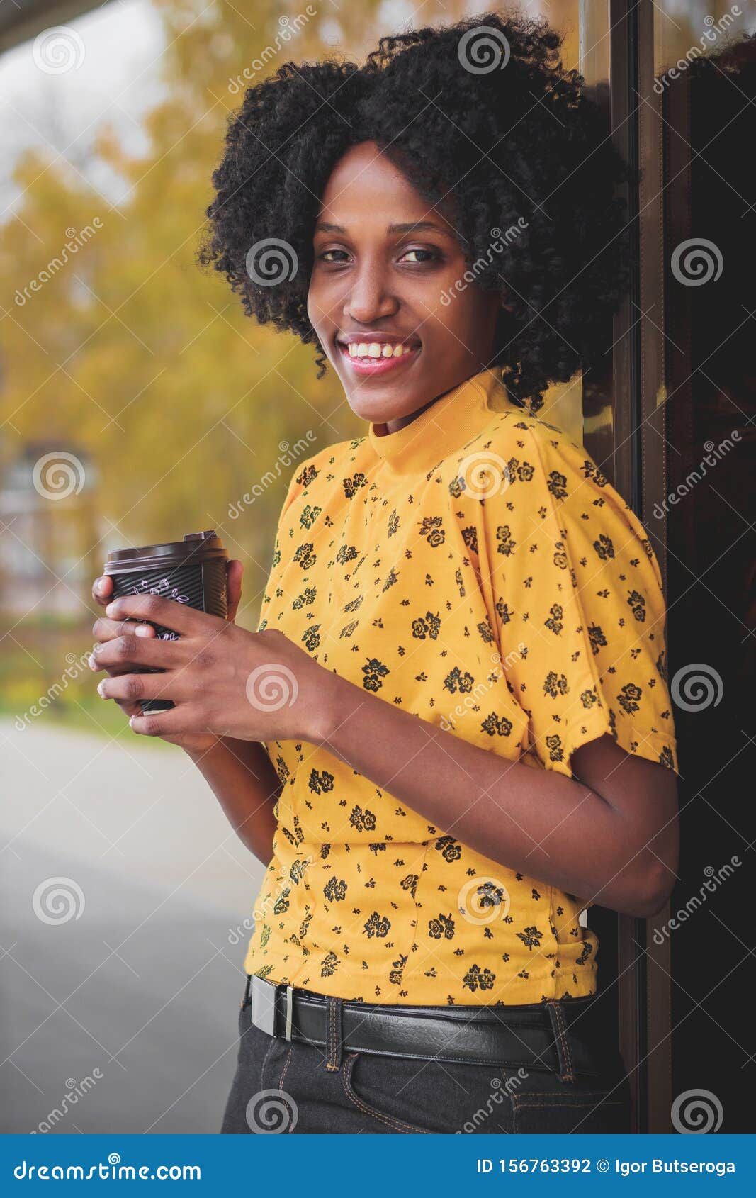 Young Dark Skinned Woman Dressed In Casual Clothes Holding Cup Of Hot