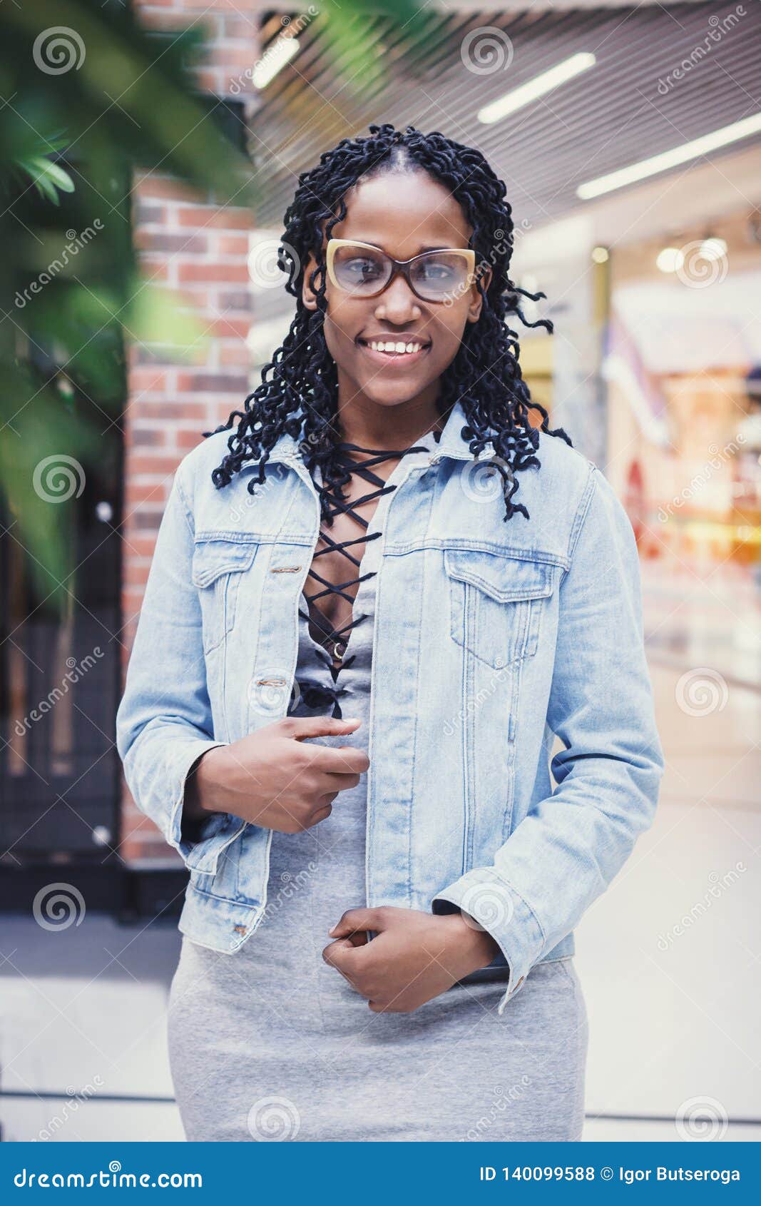 Young Dark Skinned Woman Dressed In Casual Clothes In The Mall Stock