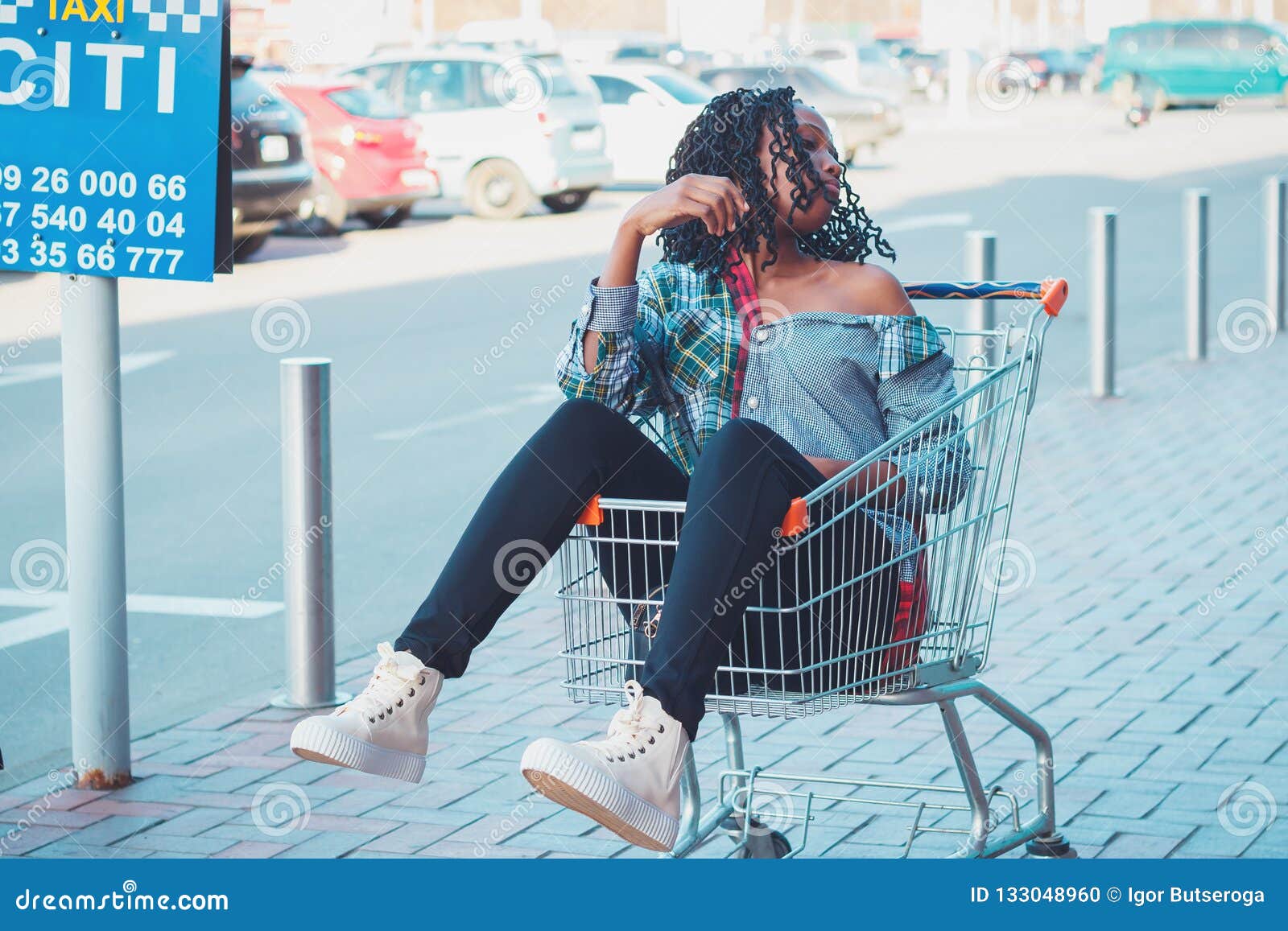 Young Dark Skinned Woman Dressed In Casual Clothes Sitting In The