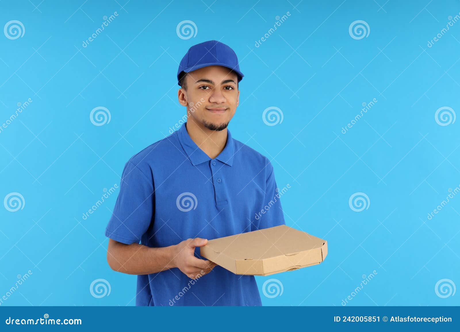 Young Delivery Man in Cap on Blue Background Stock Image - Image of ...