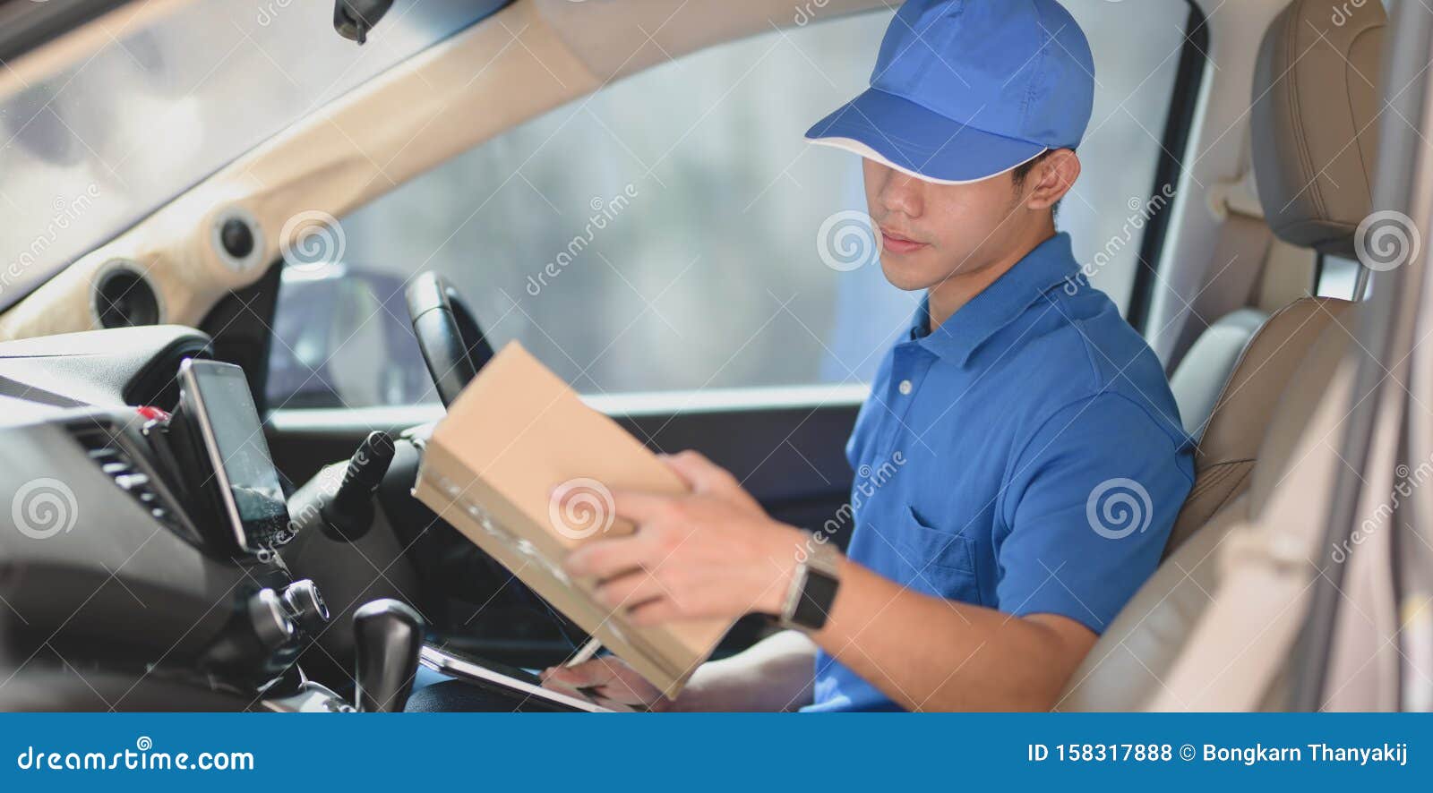 Young Delivery Man Checking Orders while Preparing the Products To ...