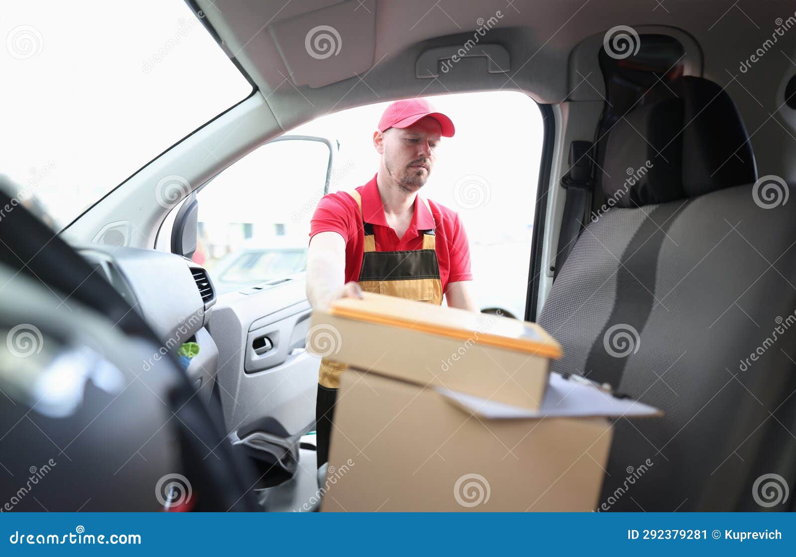 Young Delivery Man is Loading Boxes into Car Stock Image - Image of ...