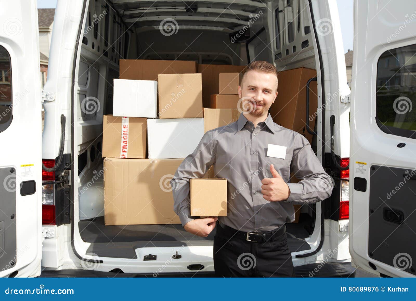 Young Delivery Man with a Parcel. Stock Photo - Image of male, goods ...