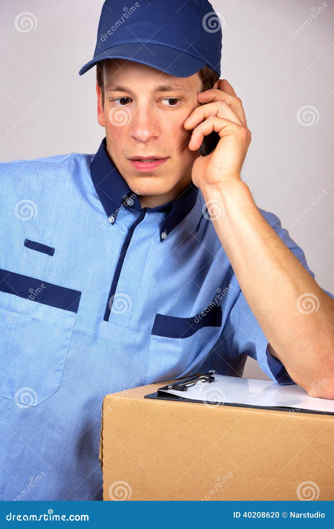 Young Delivery Man, Speaking on the Mobile Stock Photo - Image of gift ...