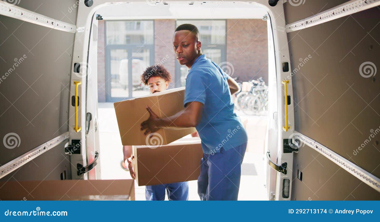 Young Delivery Men Loading Cardboard Boxes Stock Photo - Image of ...