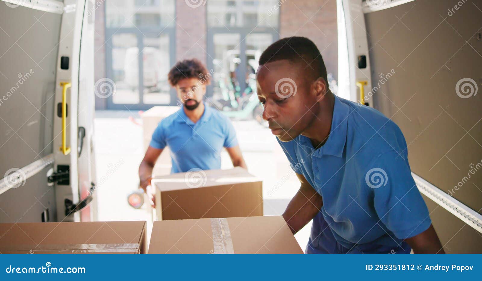 Young Delivery Men Loading Cardboard Boxes Stock Photo - Image of black ...