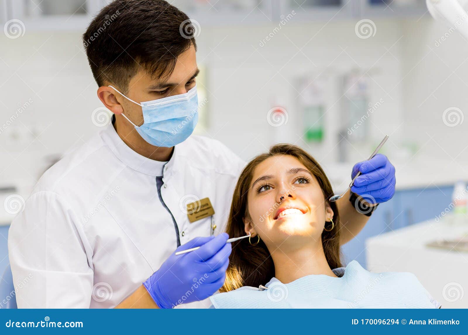 Young Dentist at Work in the Office Curing the Patient Stock Photo ...