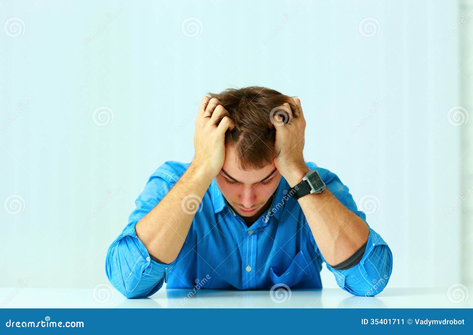Young Depressed Businessman Sitting at the Table and Looking Down Stock ...