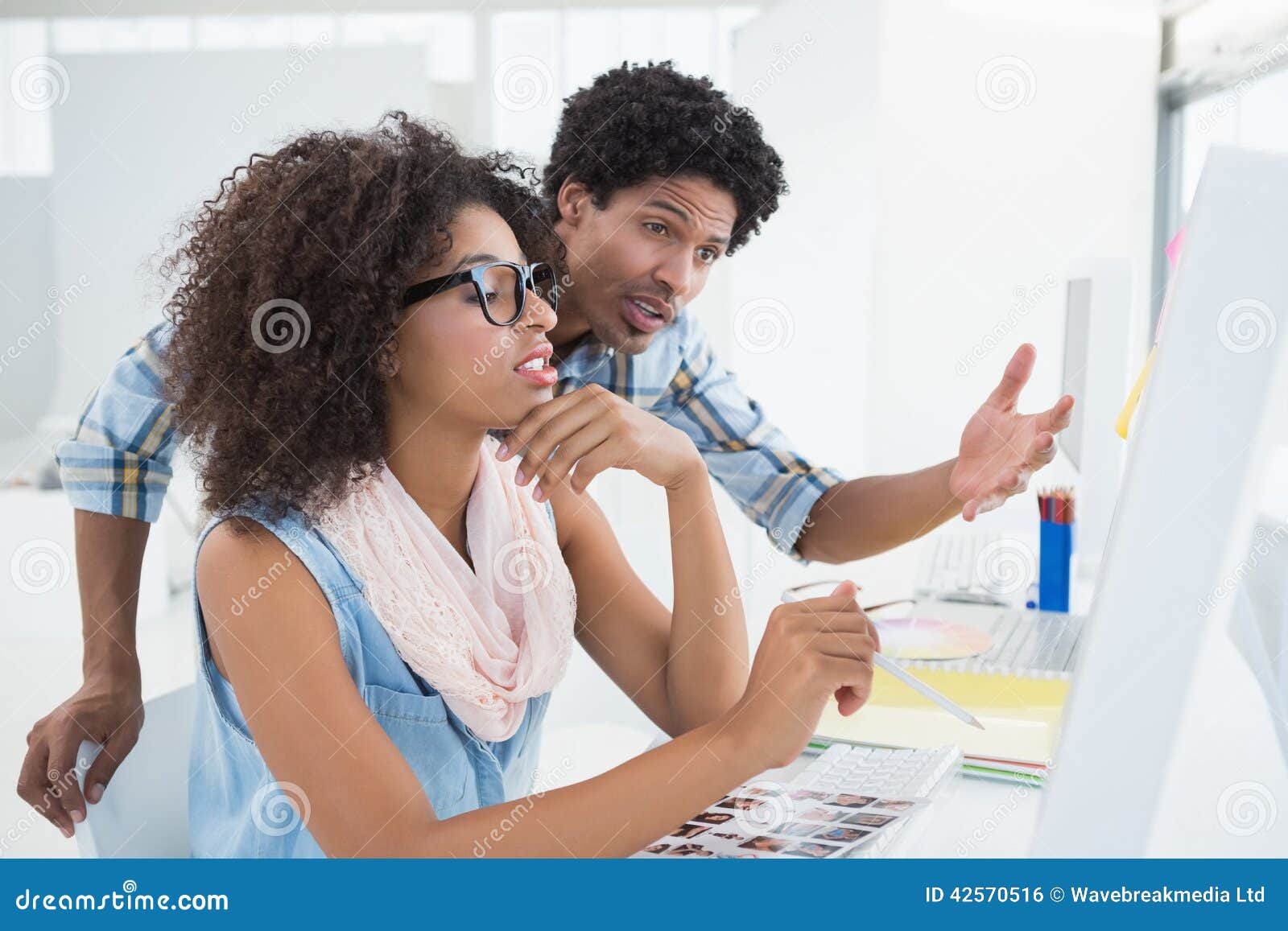 Young Design Team Working Together at Desk Stock Photo - Image of ...