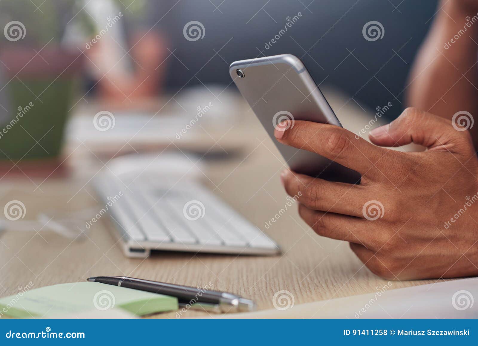 Young Designer Using a Cellphone at His Office Desk Stock Photo - Image ...