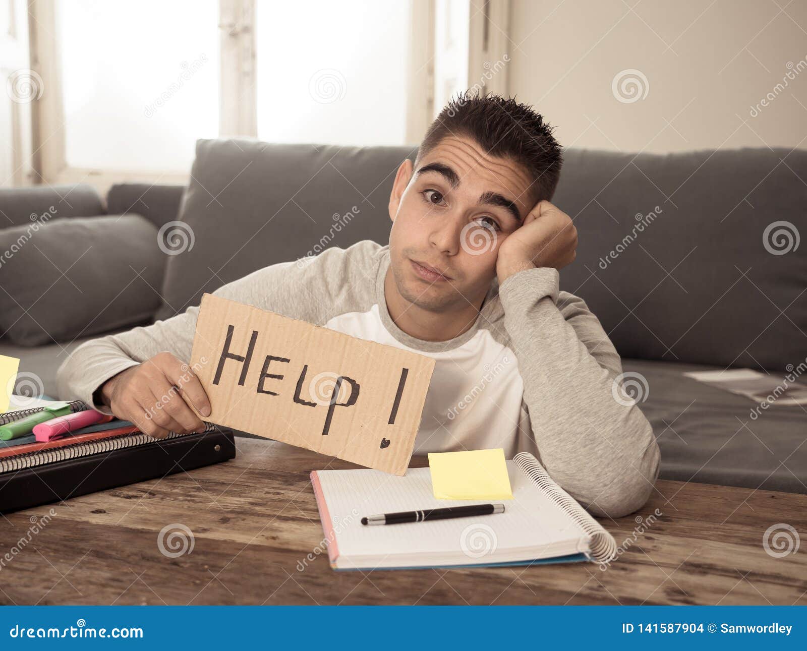 Young Desperate Student in Stress Working and Studying Holding a Help ...