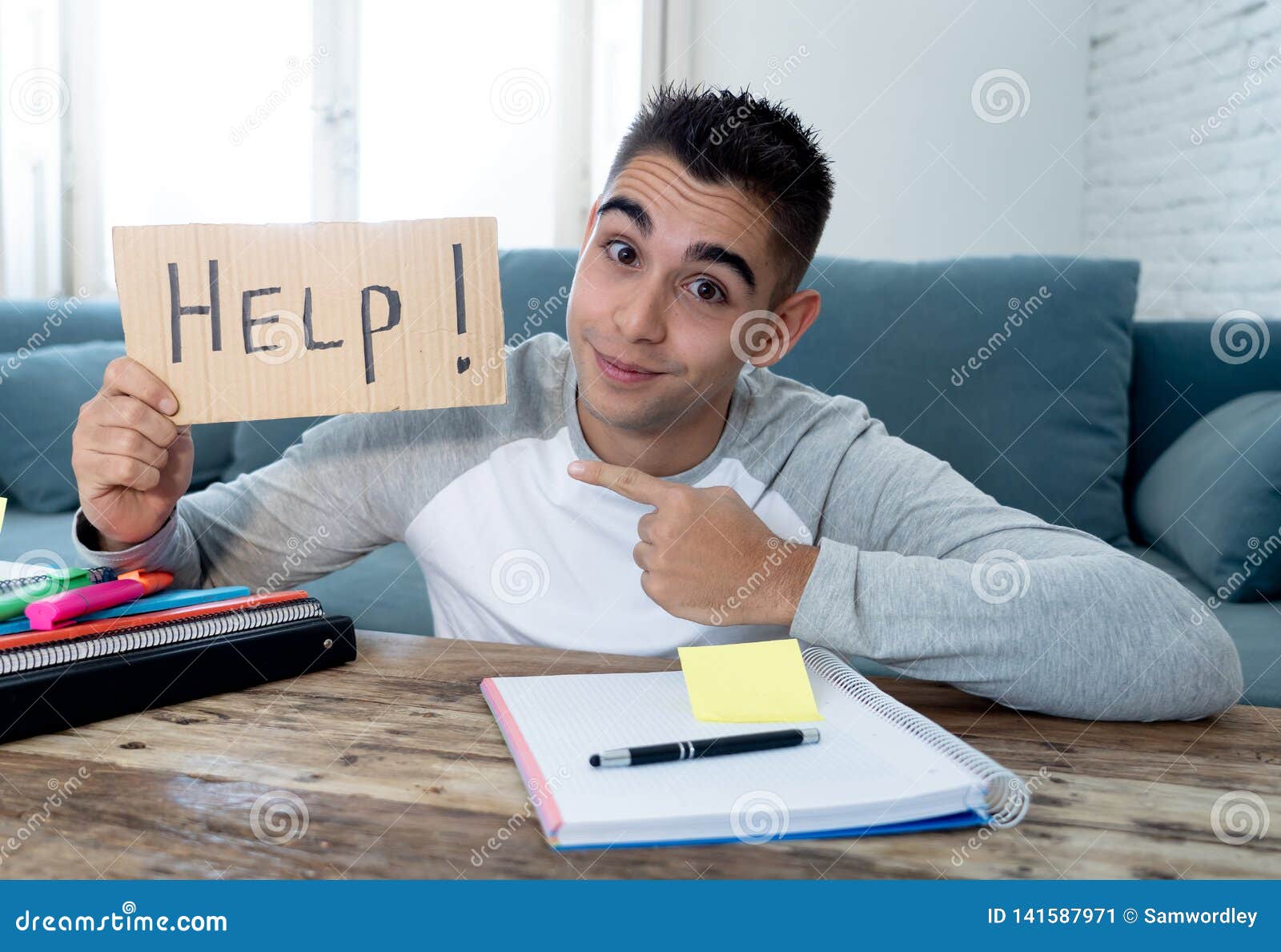 Young Desperate Student in Stress Working and Studying Holding a Help ...