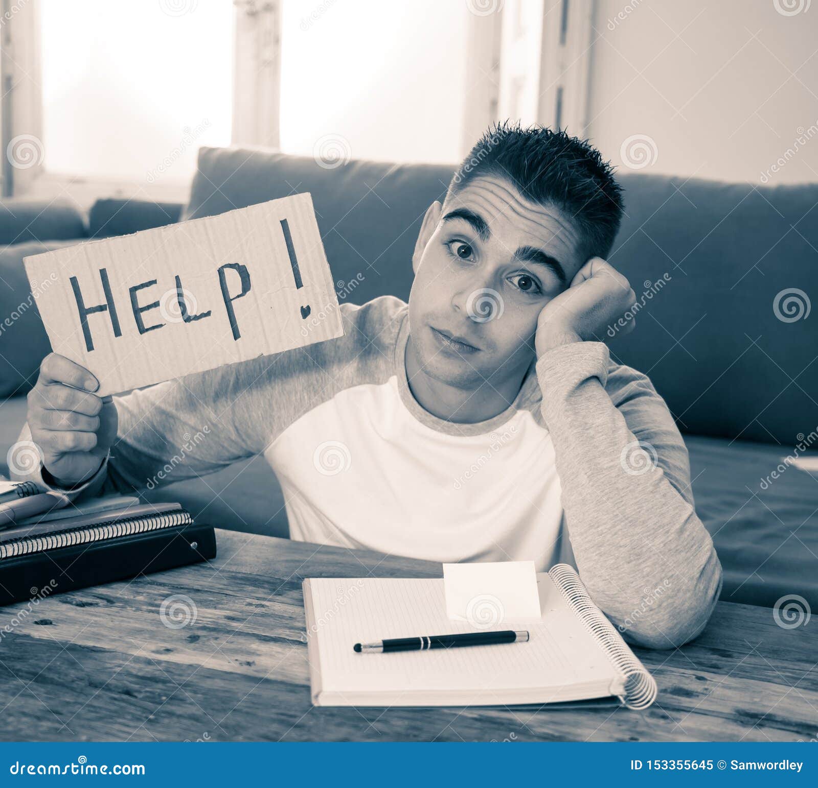 Young Desperate Student in Stress Working and Studying Holding a Help ...