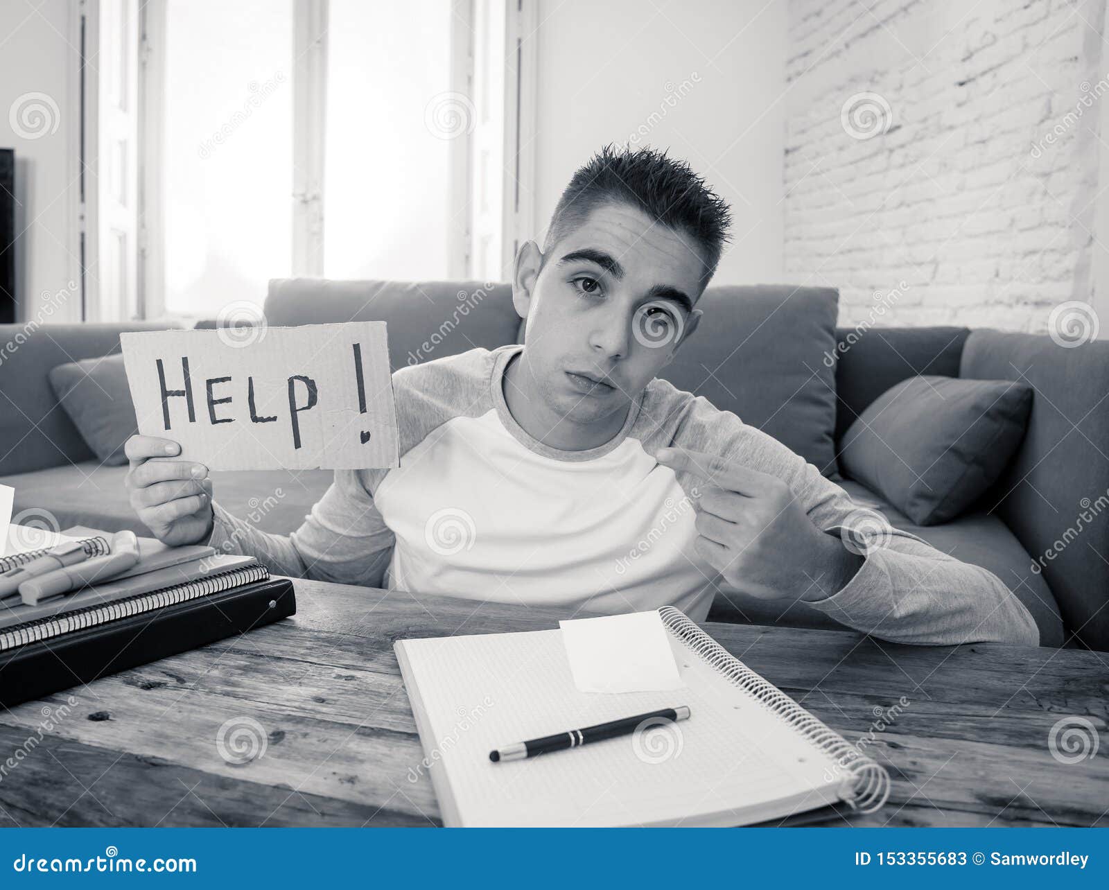 Young Desperate Student in Stress Working and Studying Holding a Help ...