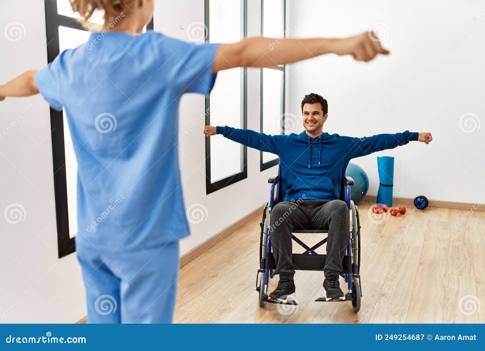 Young Disabled Man Making Mobility Exercise Sitting on Wheelchair at ...