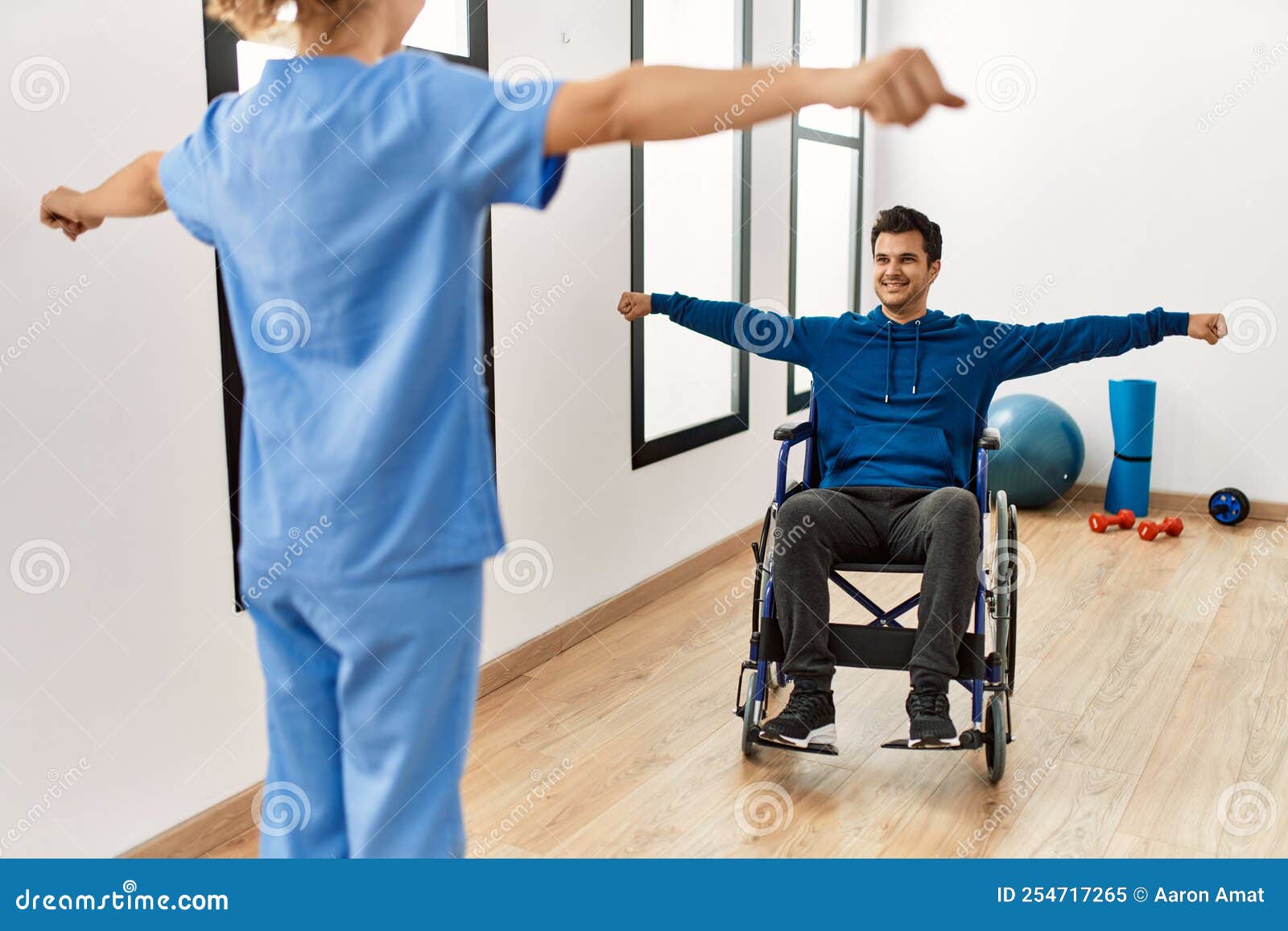 Young Disabled Man Making Mobility Exercise Sitting on Wheelchair at ...