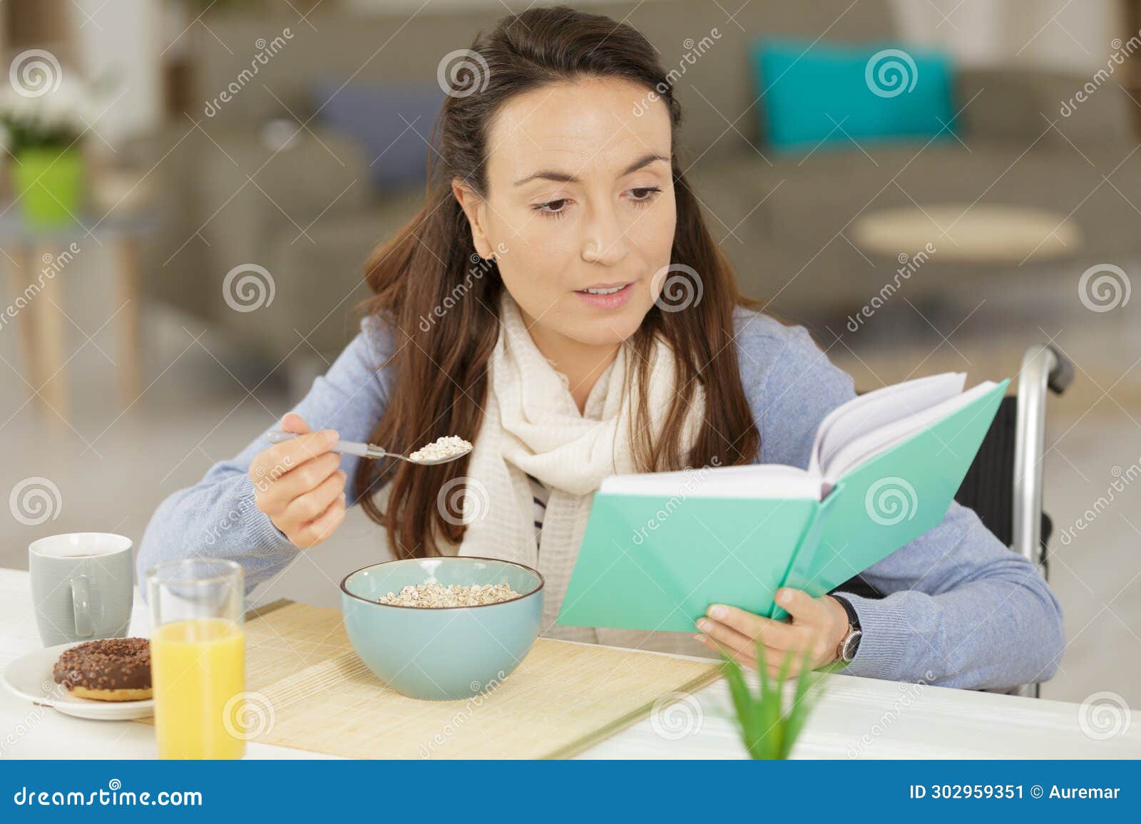 Young Disabled Woman Reading Book while Eating Breakfast Stock Image ...