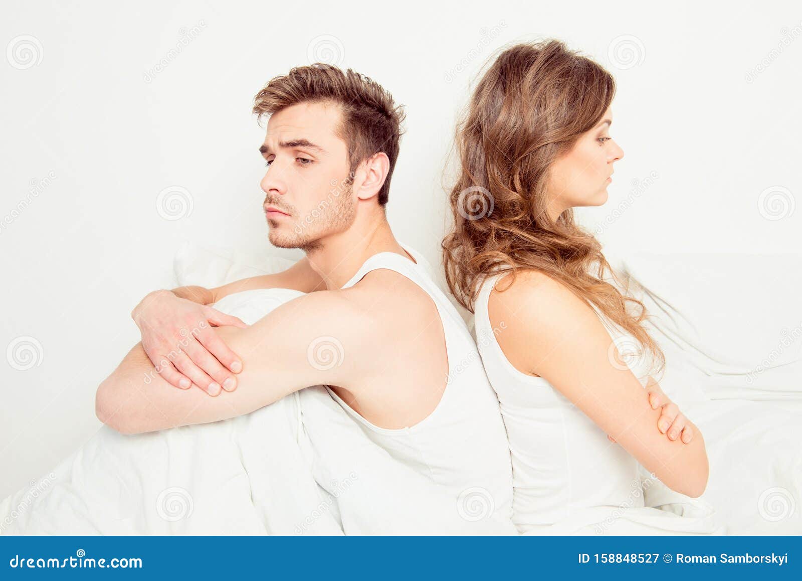 Young Disconnected Couple with Problems Sitting on the Bed Stock Image ...