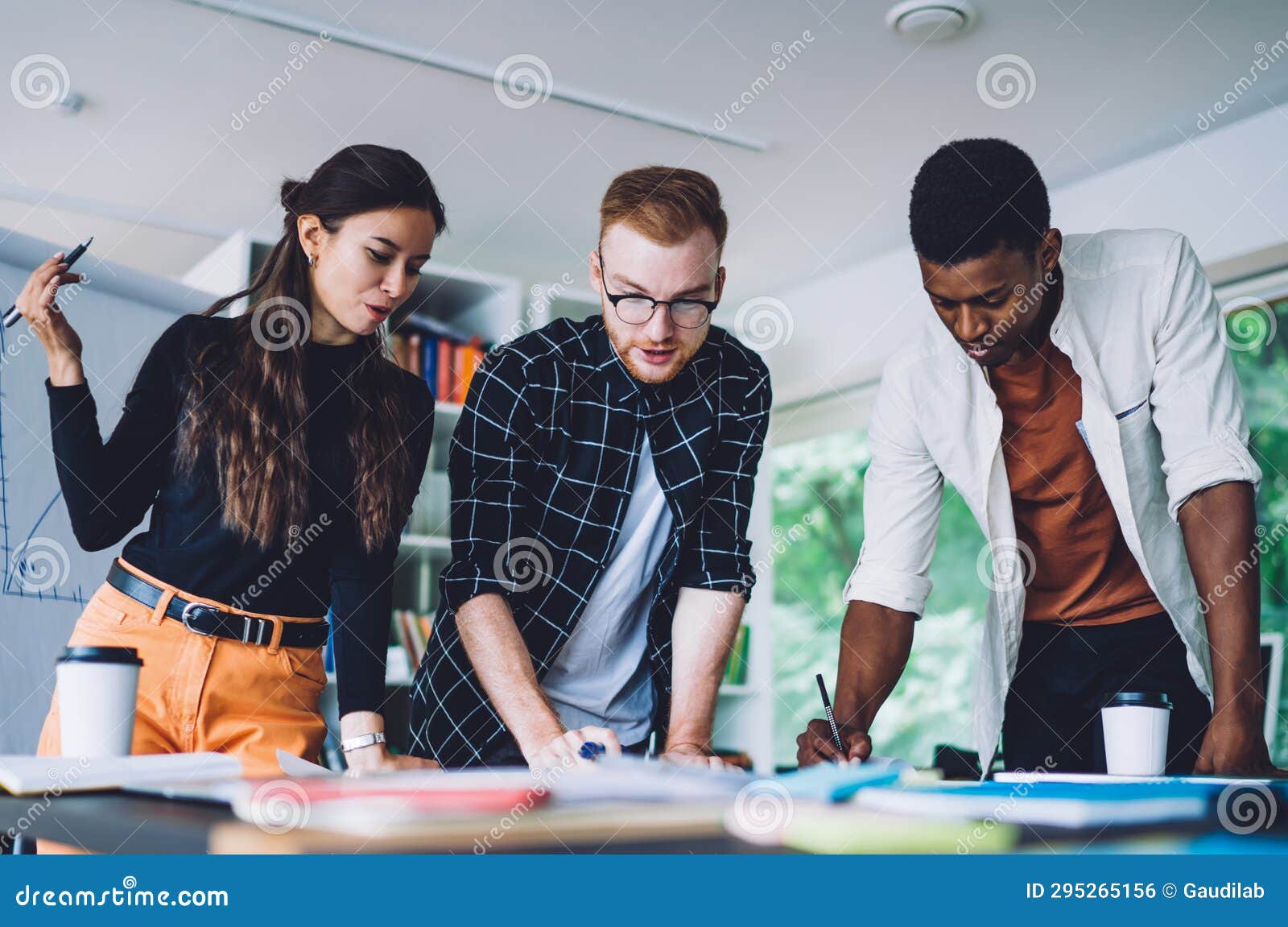 Young Diverse Coworkers Drawing and Talking in Office Stock Photo ...