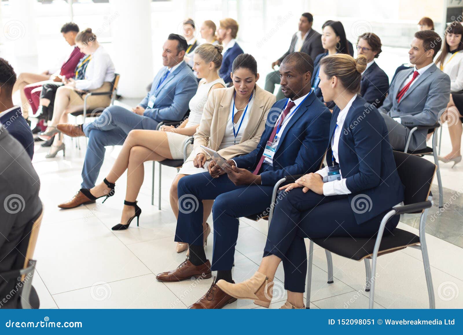 Young Diverse Executives Sat in Conference Room, Speaking Stock Image ...