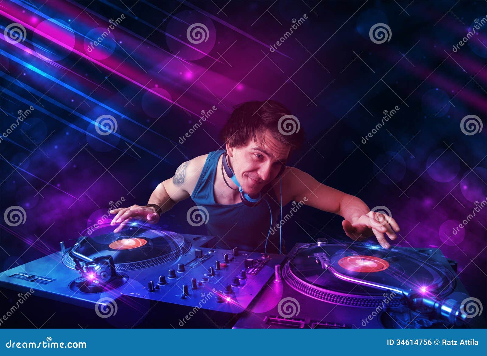 Young DJ Playing on Turntables with Color Light Effects Stock ...