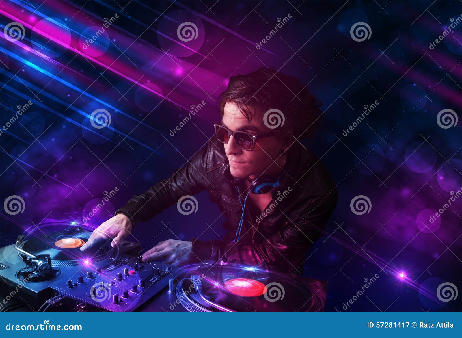 Young DJ Playing on Turntables with Color Light Effects Stock ...