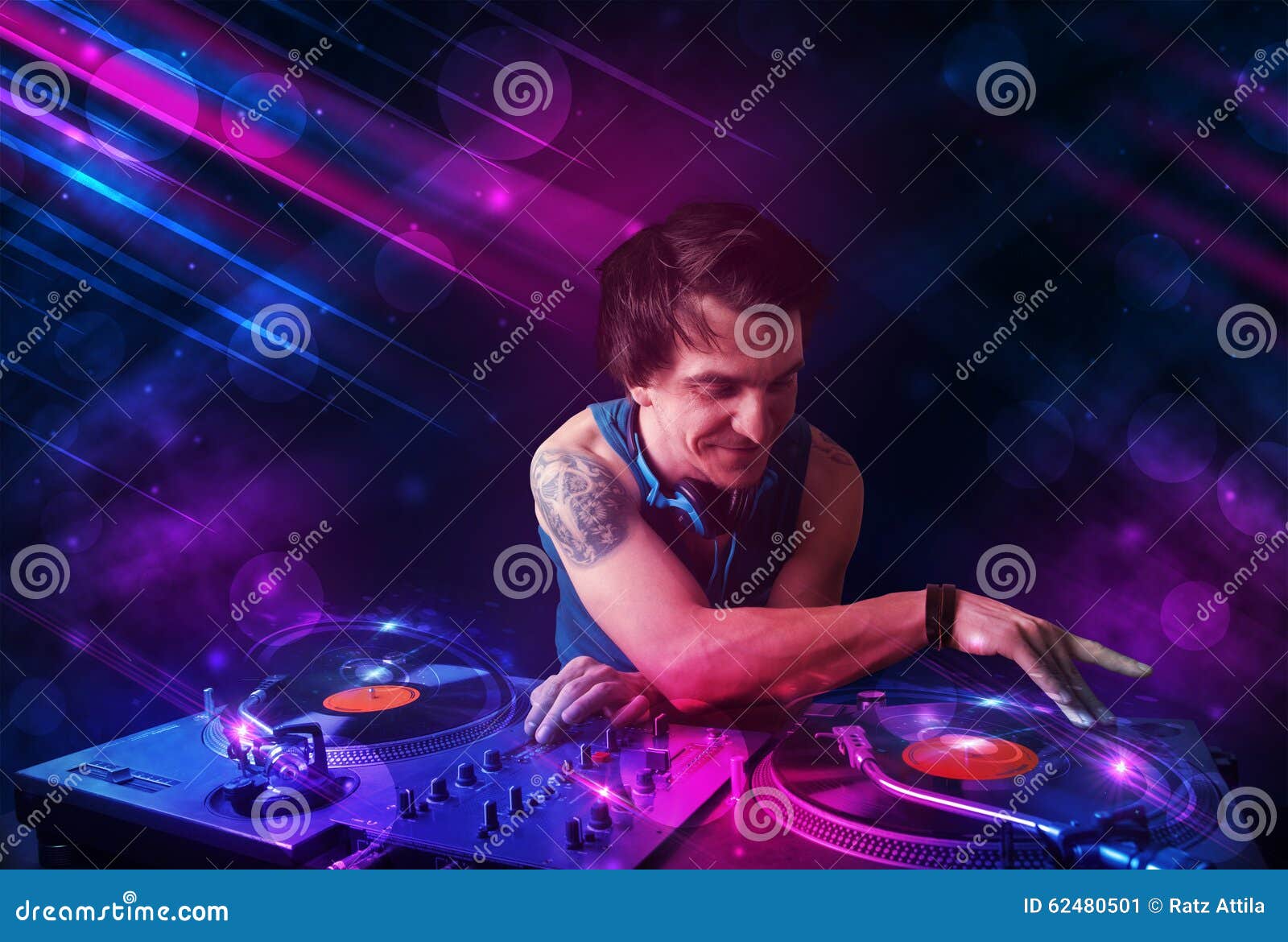 Young DJ Playing on Turntables with Color Light Effects Stock Image ...