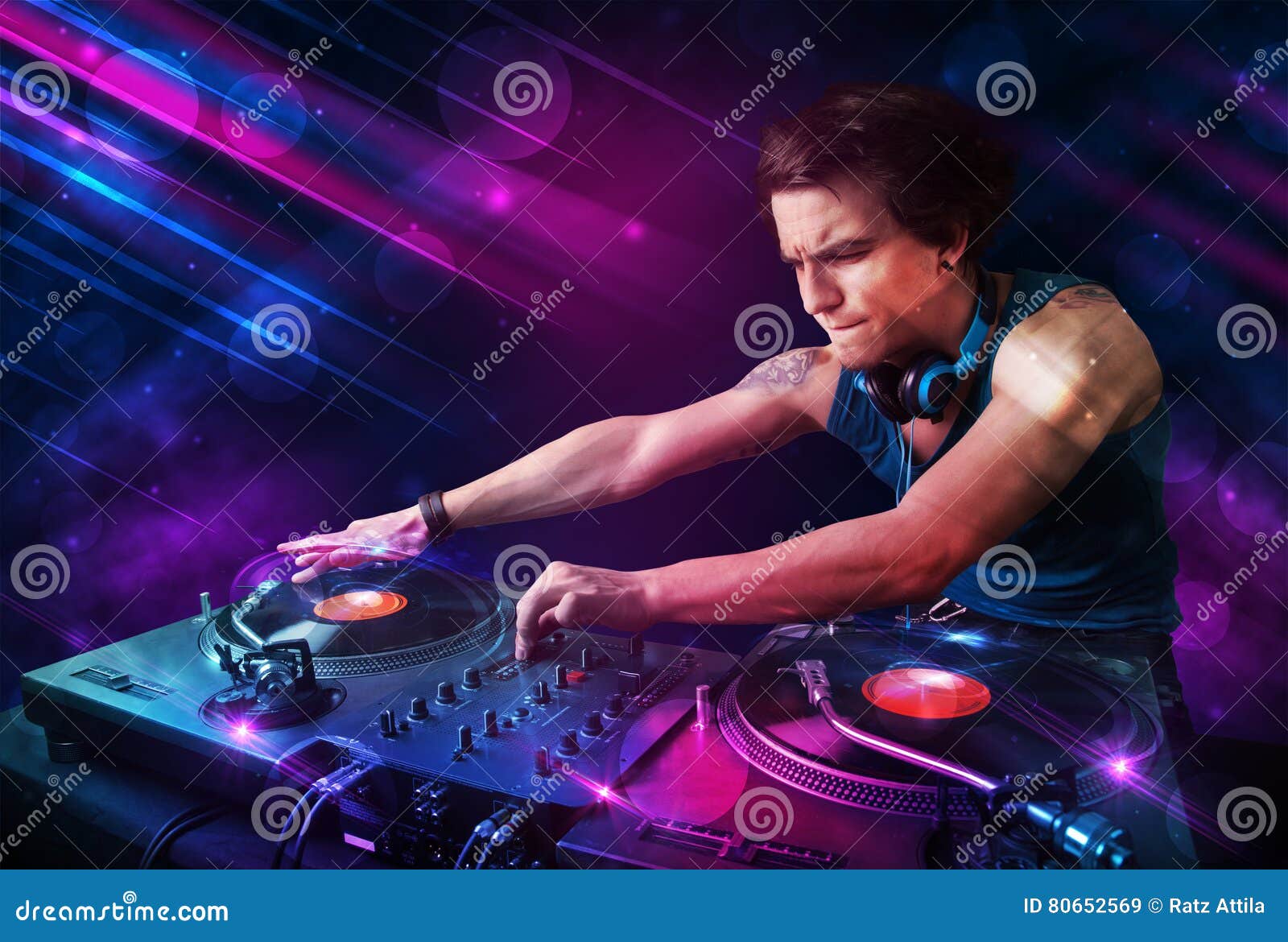 Young DJ Playing on Turntables with Color Light Effects Stock Image ...
