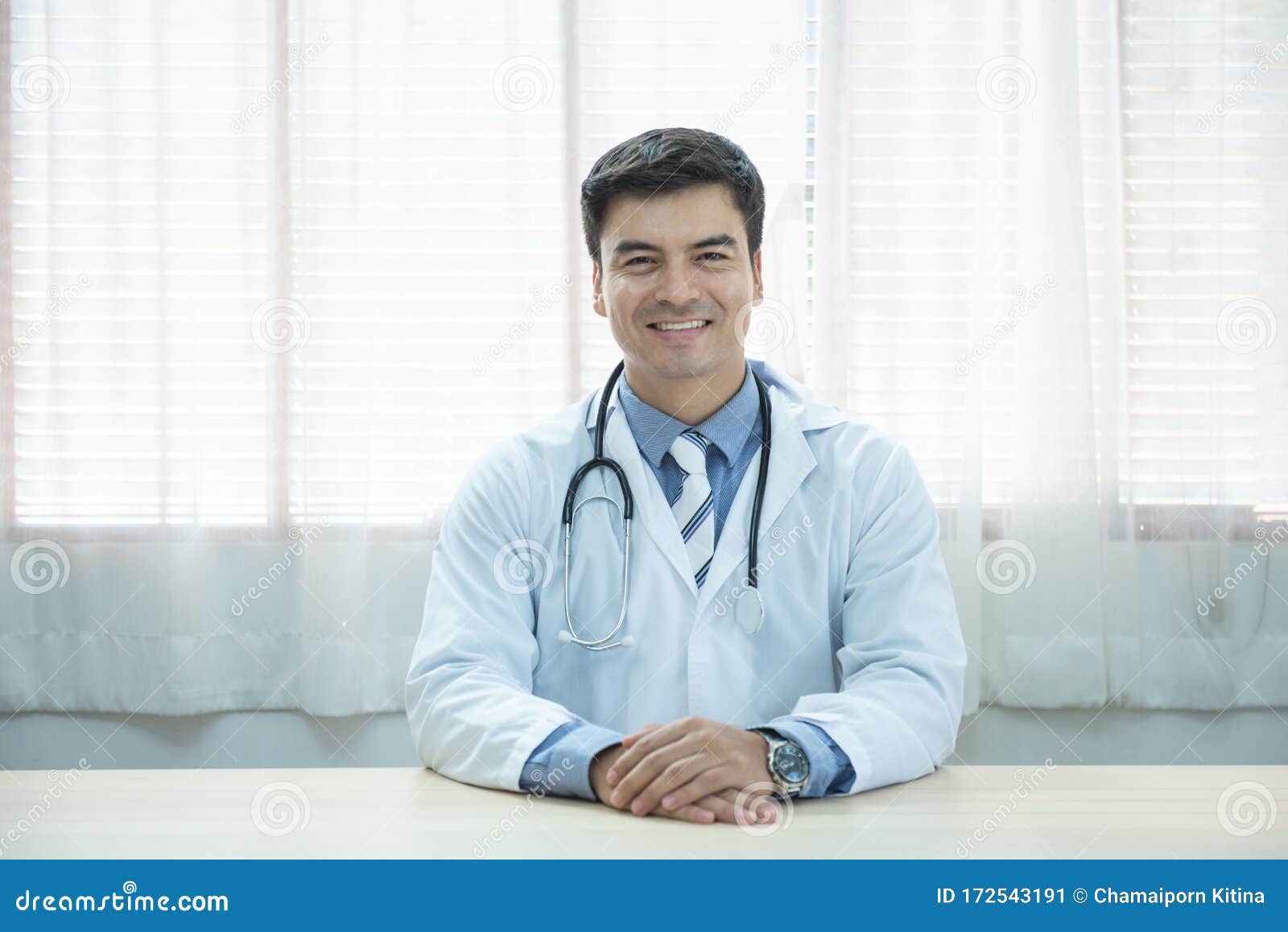Young Doctor Caucasian Man Sitting At The Desk At His Working Place And