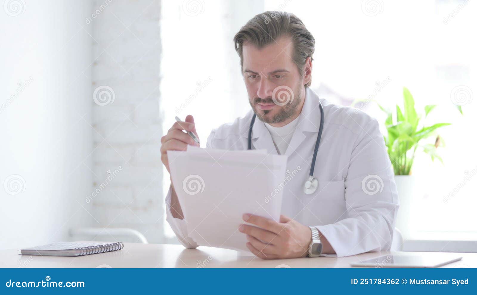 Young Doctor Doing Paperwork in Clinic Stock Footage - Video of working ...