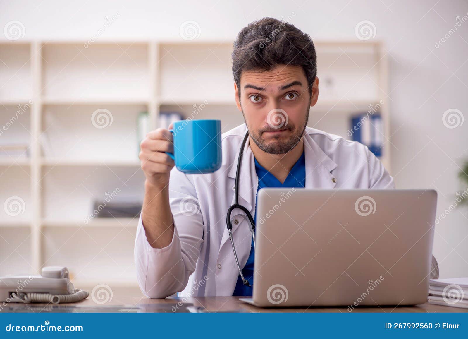 Young Male Doctor Drinking Tea during Break Stock Photo - Image of ...