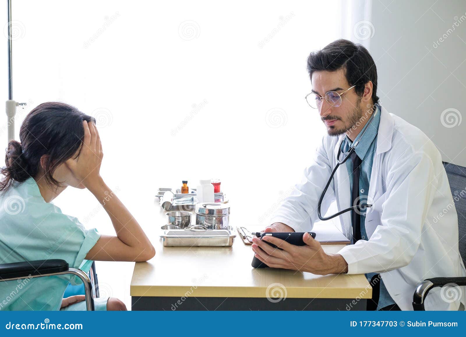 The Young Doctor Examined The Symptoms Of The Patients And Reported The Results To Patients