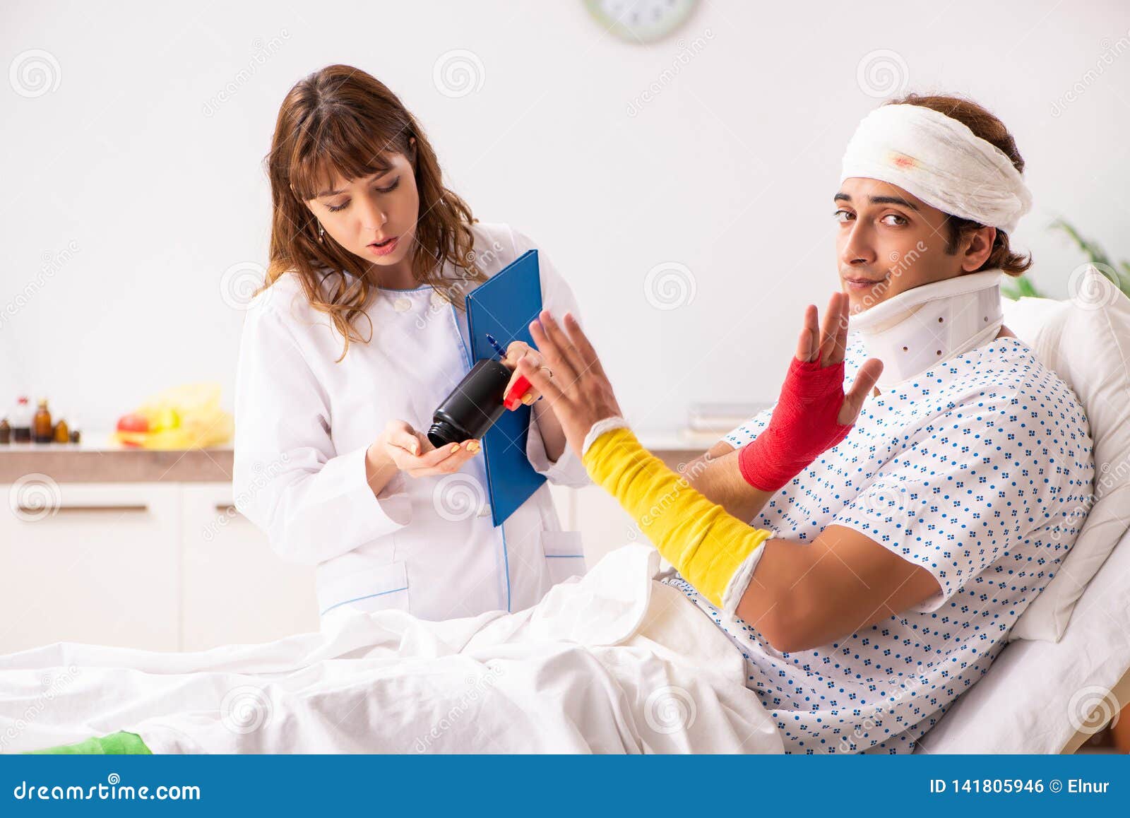 The Young Doctor Examining Injured Patient Stock Photo - Image of ...