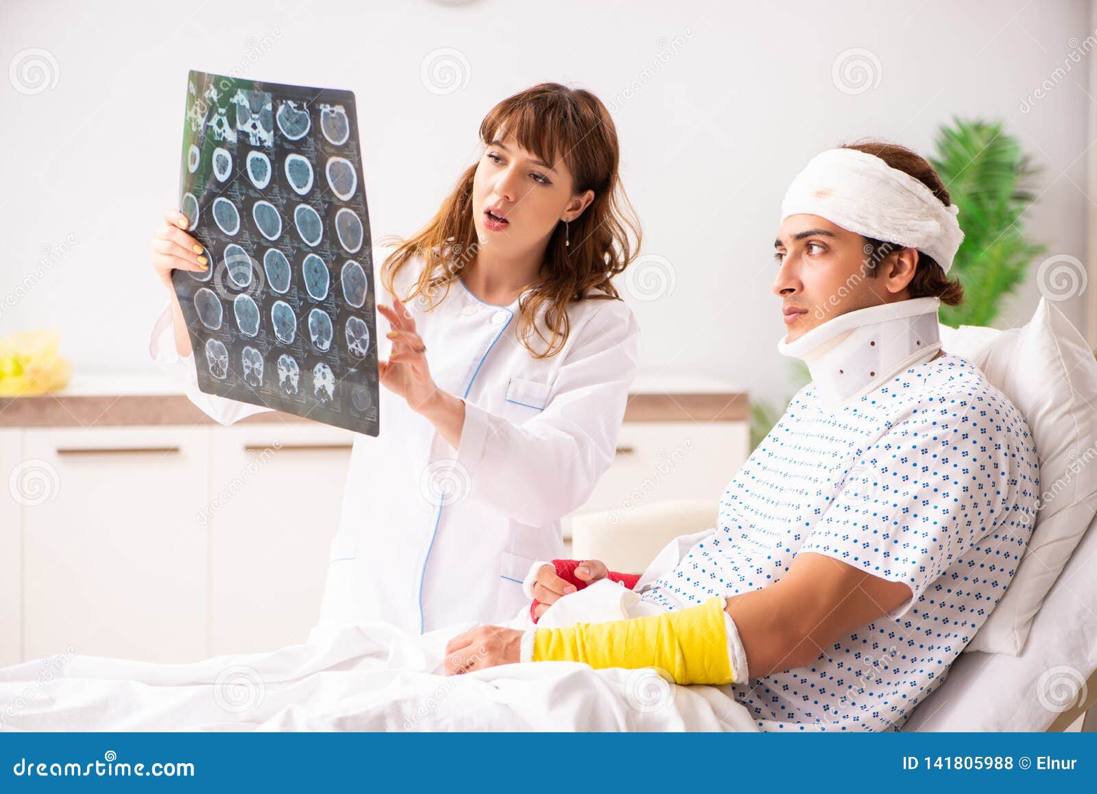 The Young Doctor Examining Injured Patient Stock Photo - Image of care ...